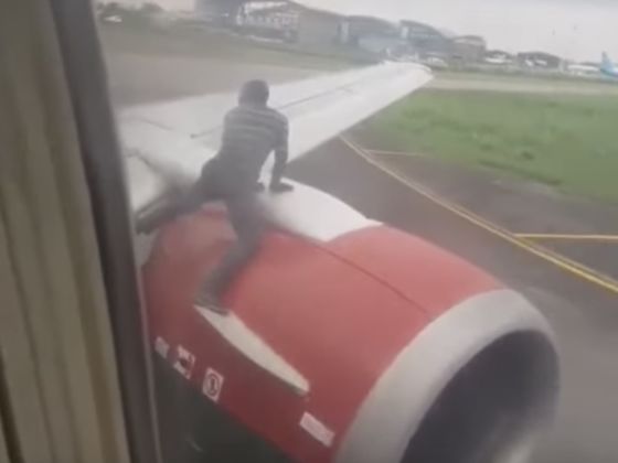 Man climbs onto plane wing